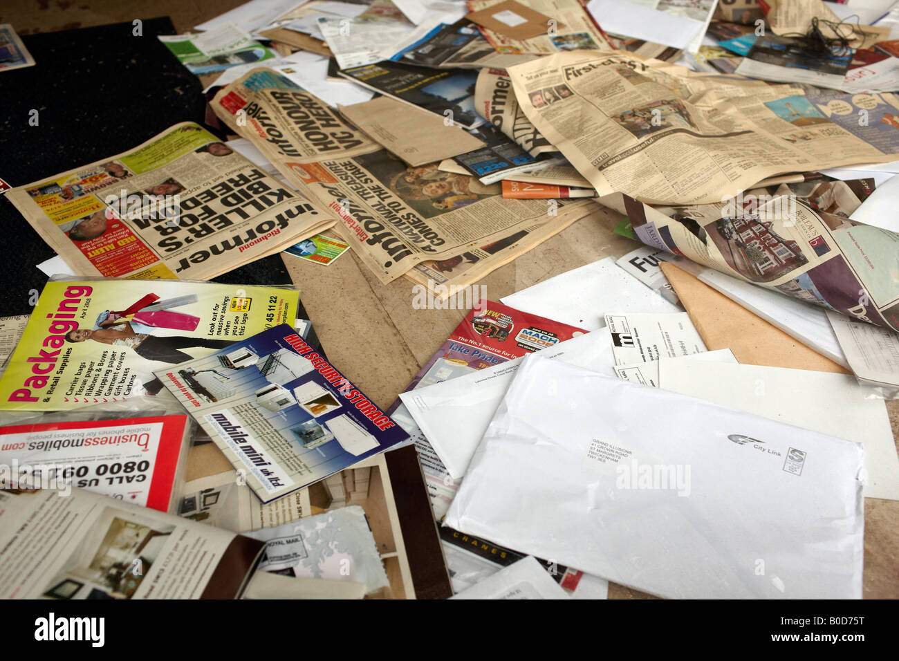 Unwanted mail piling up behind the front door of a shop that has closed ...