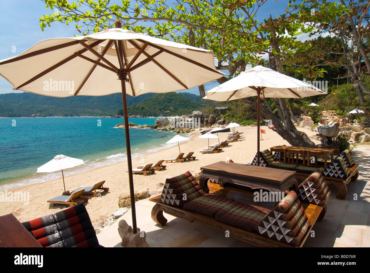 Beach chairs and tables set up on an Asian beach overlooking the ...