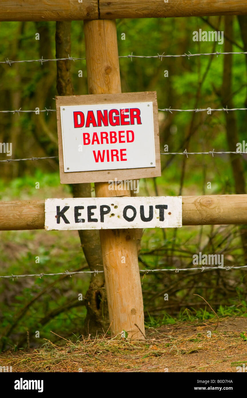 Danger barbed wire sign, portrait photograph Stock Photo - Alamy