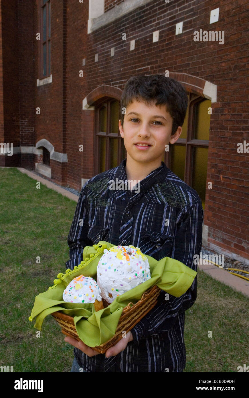 A Russian orthodox boy with Traditional Easter Koulitchis cakes brought ...