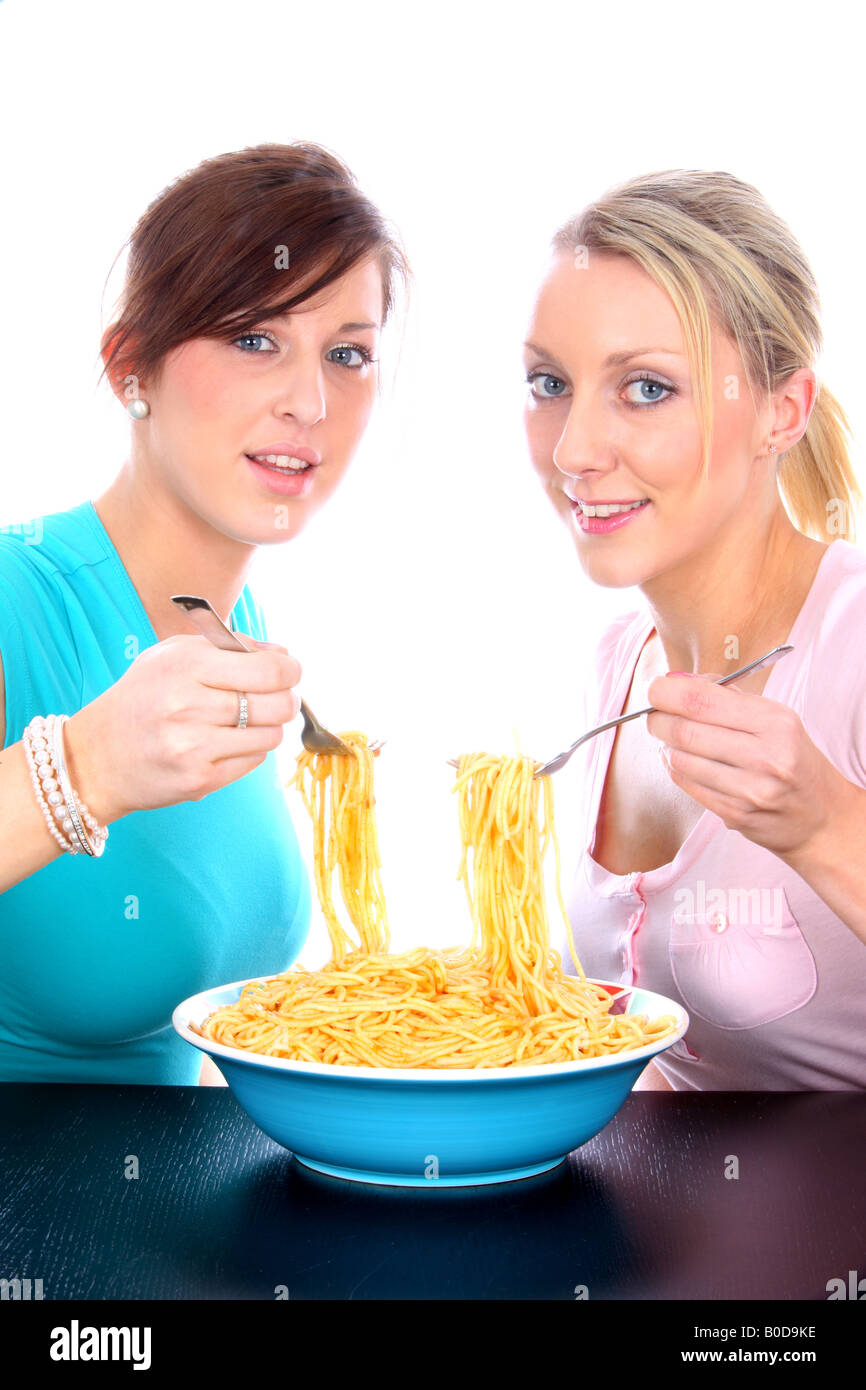 Two Girl Friends Sharing And Enjoying A Large Bowl Of Italian Spaghetti ...