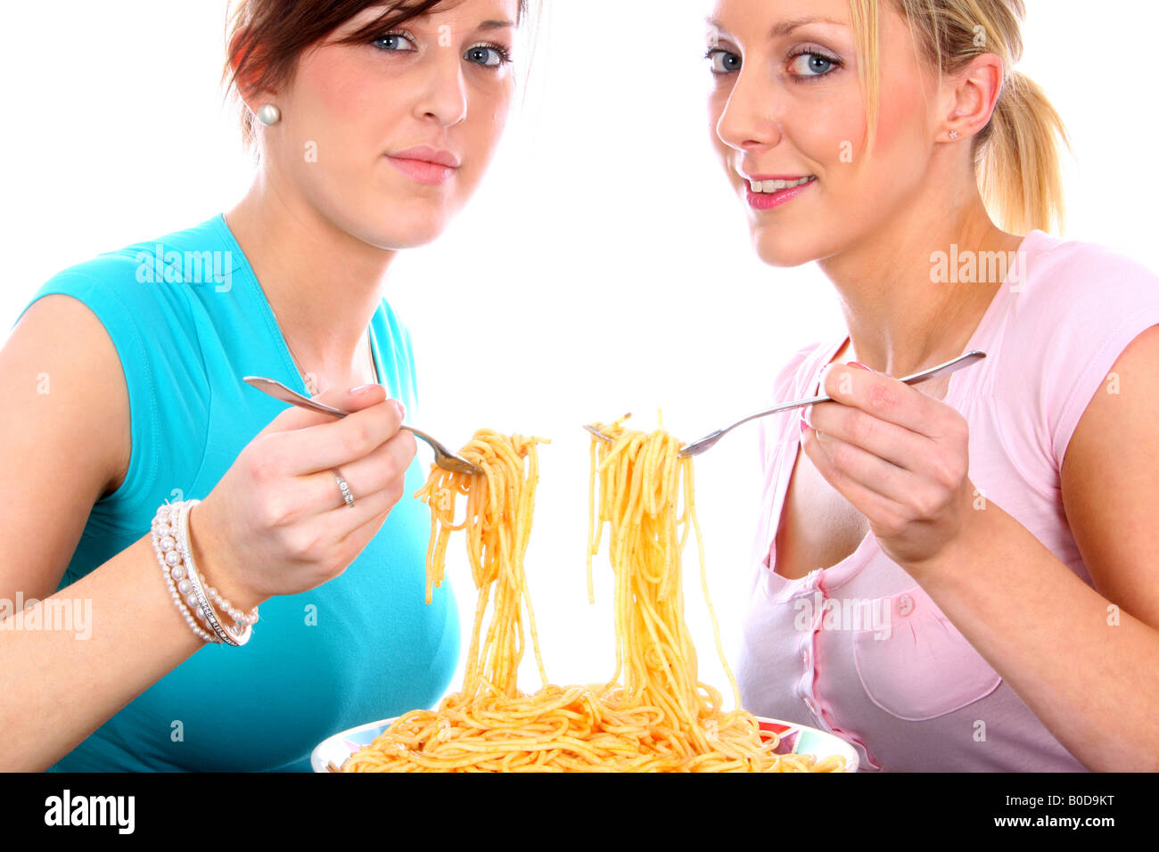 Two Girl Friends Sharing And Enjoying A Large Bowl Of Italian Spaghetti ...