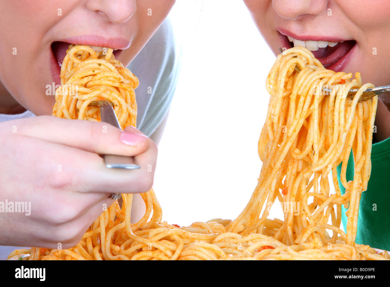 Two Girl Friends Sharing And Enjoying A Large Bowl Of Italian Spaghetti ...