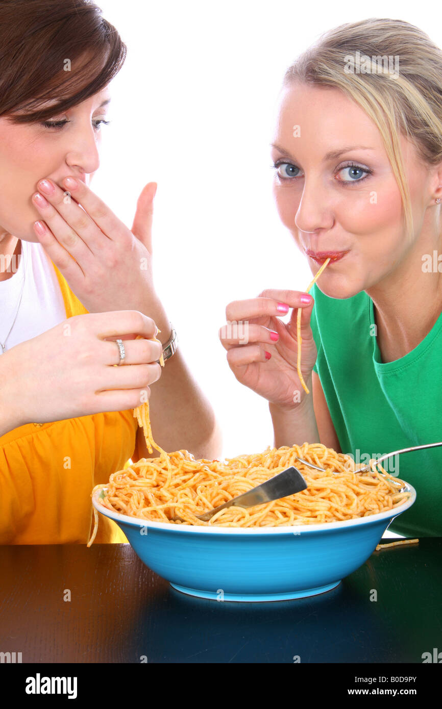 Two Girl Friends Sharing And Enjoying A Large Bowl Of Italian Spaghetti ...
