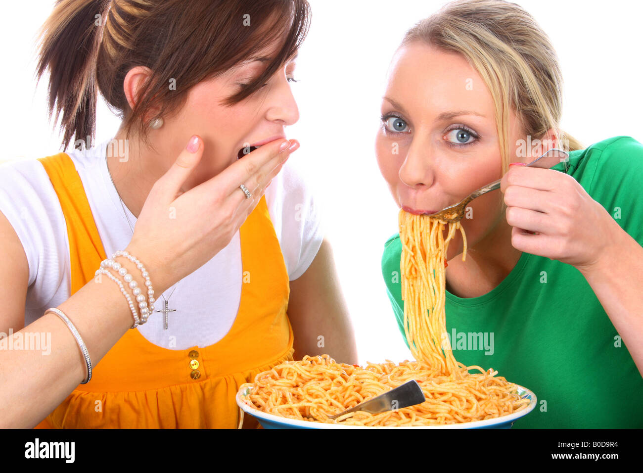 Two Girl Friends Sharing And Enjoying A Large Bowl Of Italian Spaghetti ...