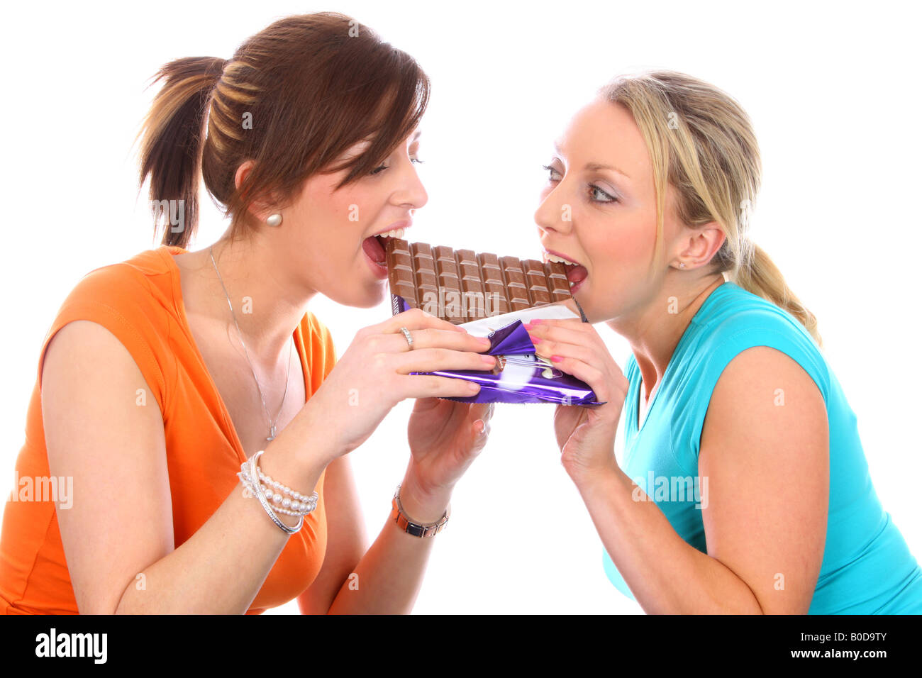 Young Women Eating Chocolate Bar Model Released Stock Photo - Alamy