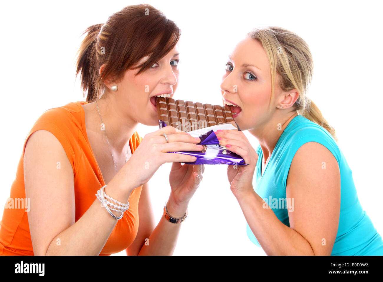 Young Women Eating Chocolate Bar Model Released Stock Photo - Alamy