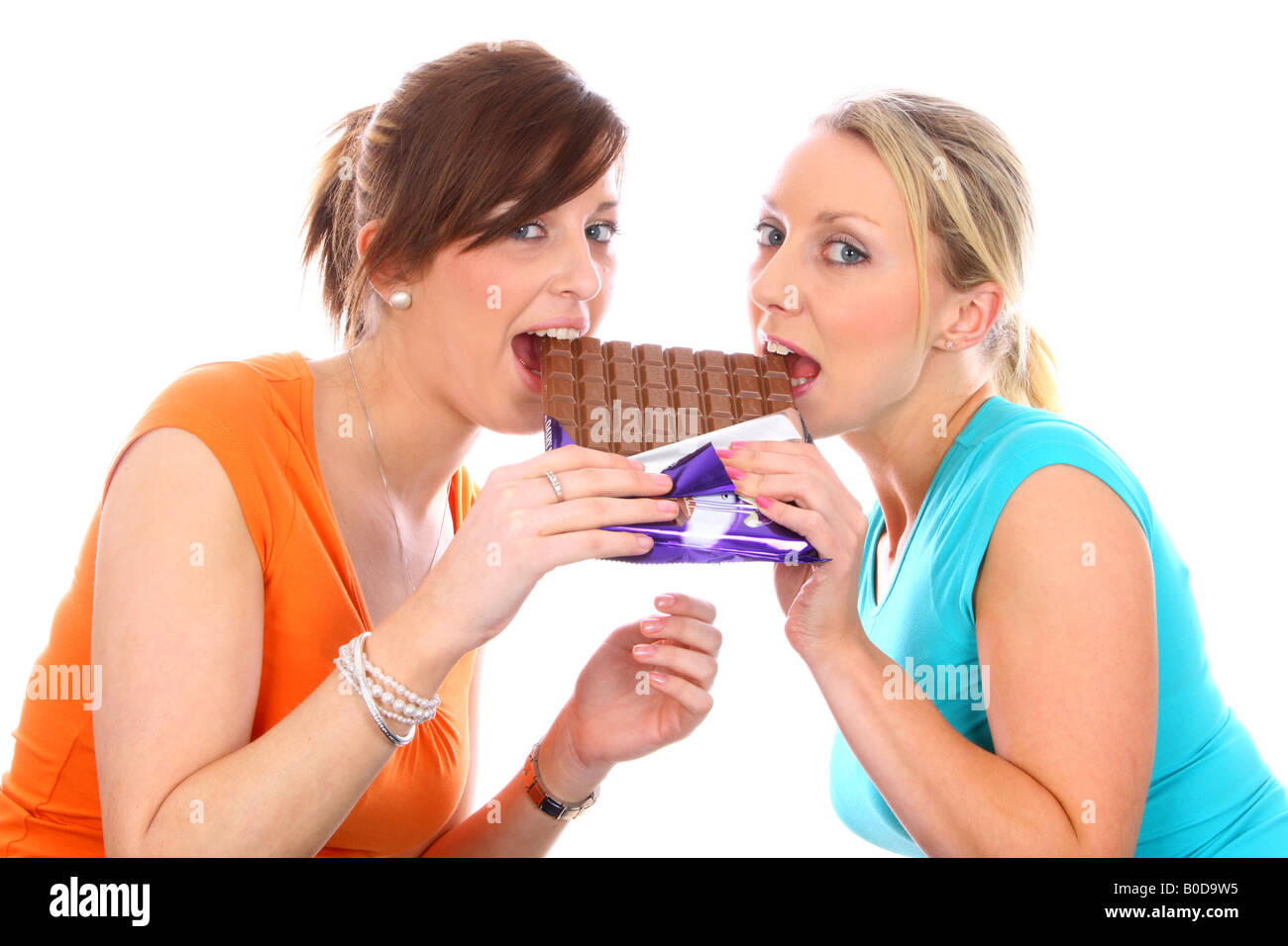 Young Women Eating Chocolate Bar Model Released Stock Photo - Alamy