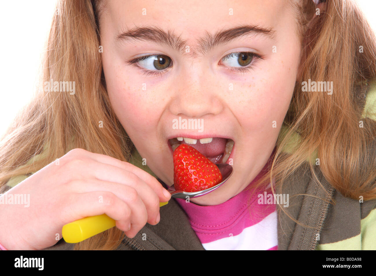 Young Girl Eating a Strawberry Model Released Stock Photo - Alamy