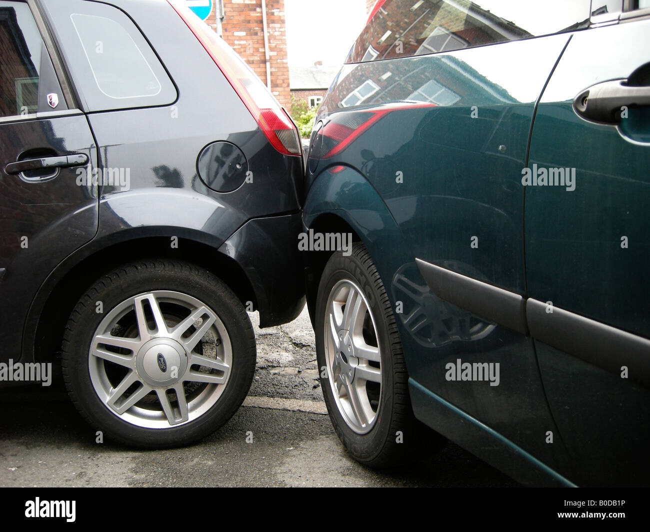 two cars parked too closely to one another Stock Photo - Alamy