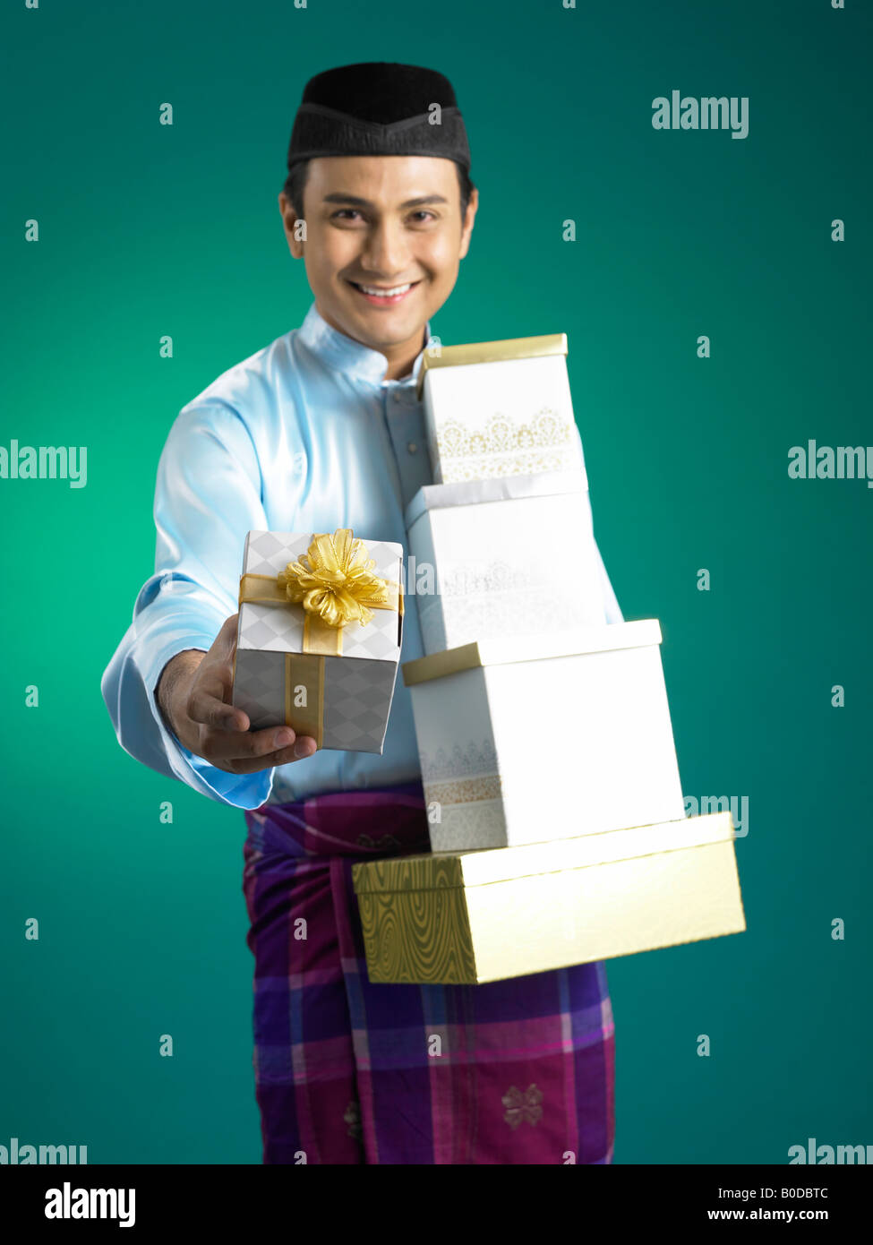 Man smiling and giving gift Stock Photo - Alamy