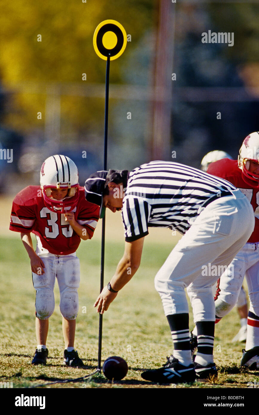 Referee measuring for a first down during a during a pee wee football ...
