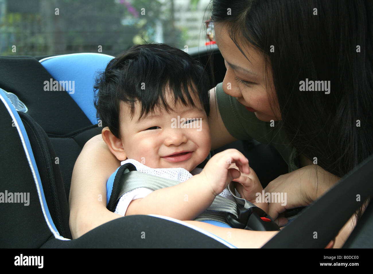 Mother hugging baby boy inside car Stock Photo - Alamy