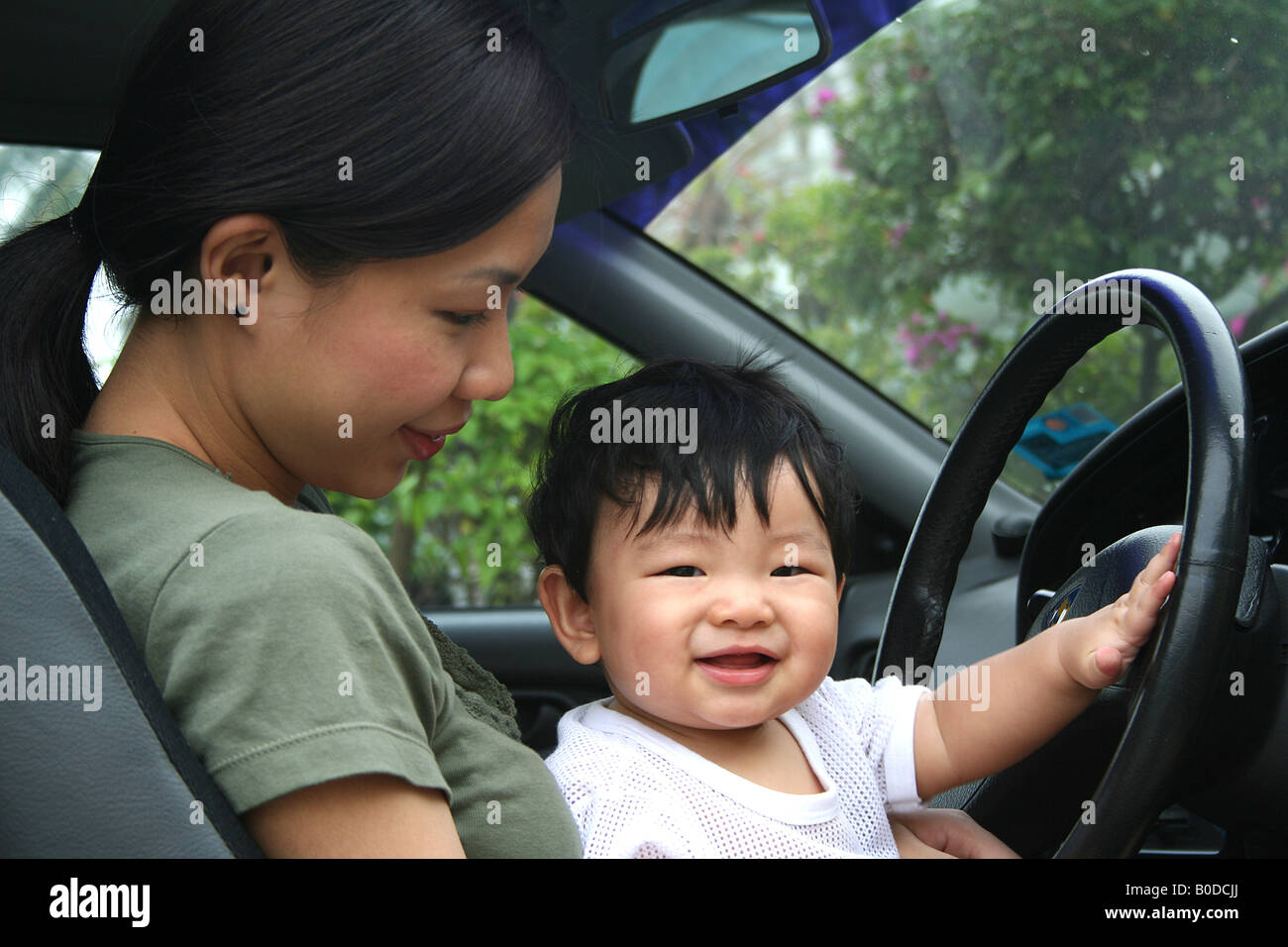 Mother and baby boy inside car Stock Photo - Alamy