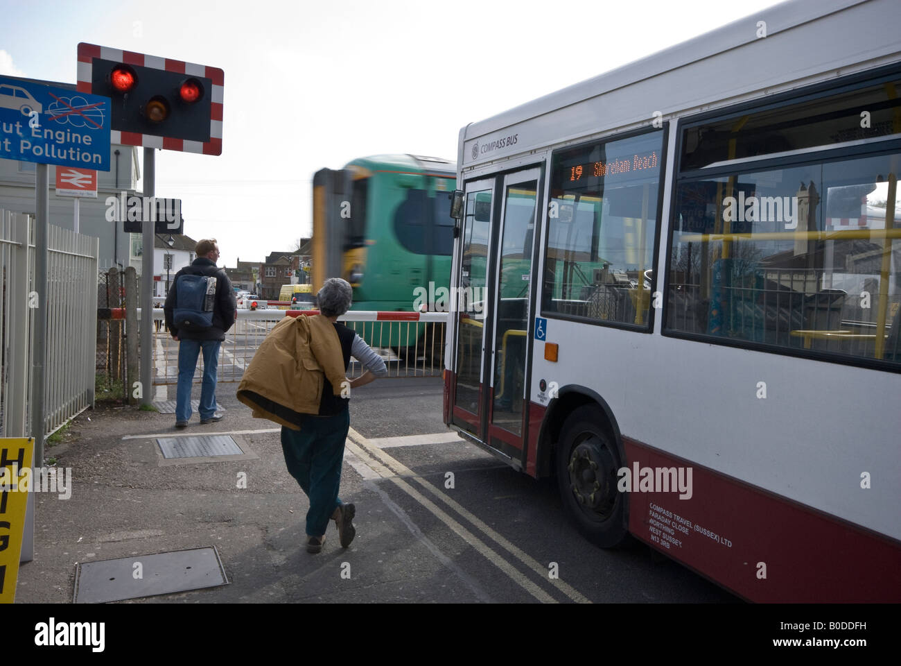 Bus Pedestrians waiting level crossing Stock Photo - Alamy