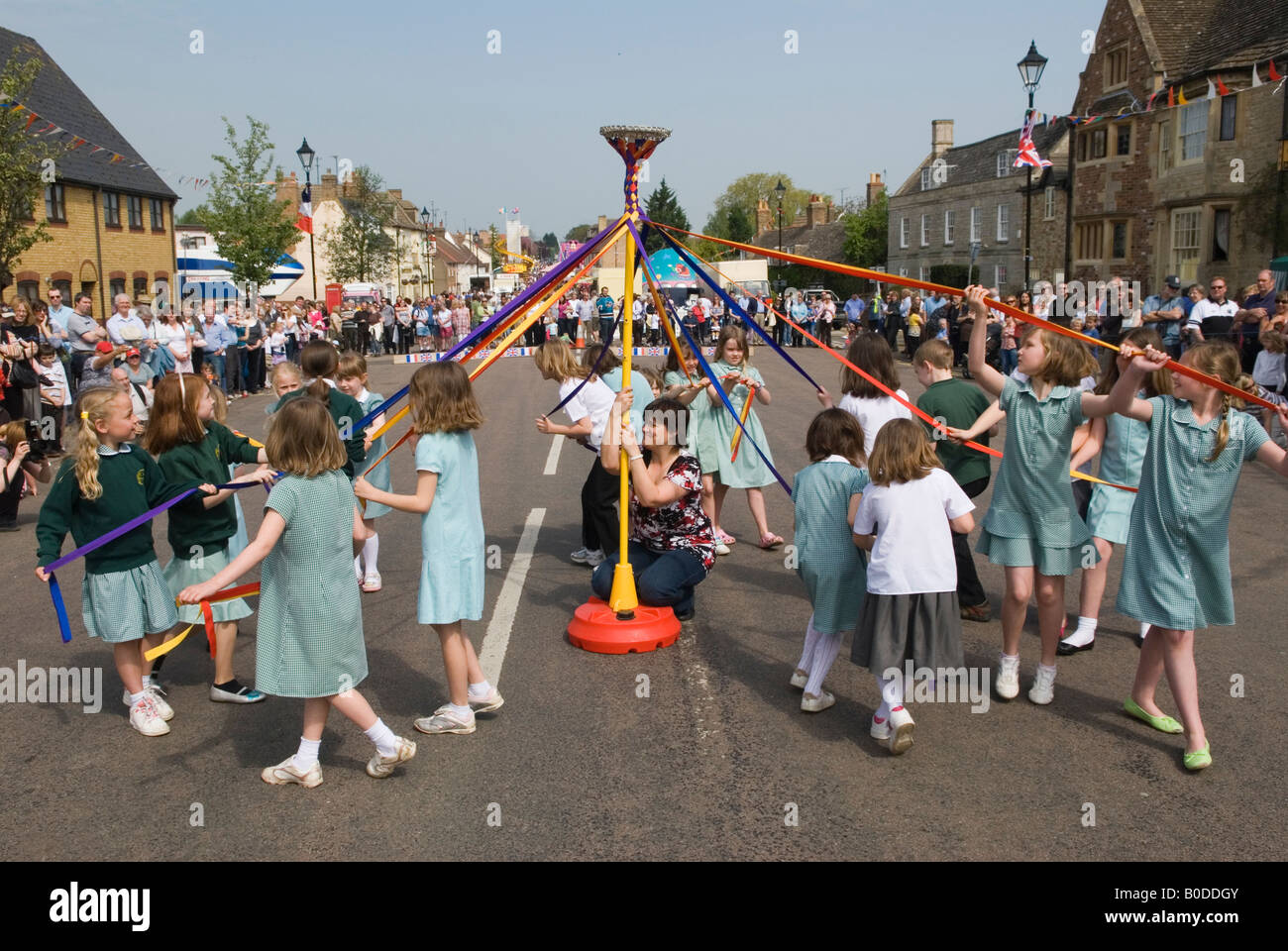 Maypole dancing May Day village festival Uk. Schoolchildren dancing ...