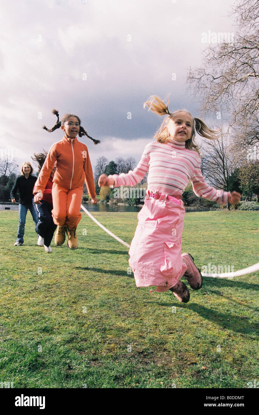 Teacher and school children playing withe skipping rope Stock Photo - Alamy