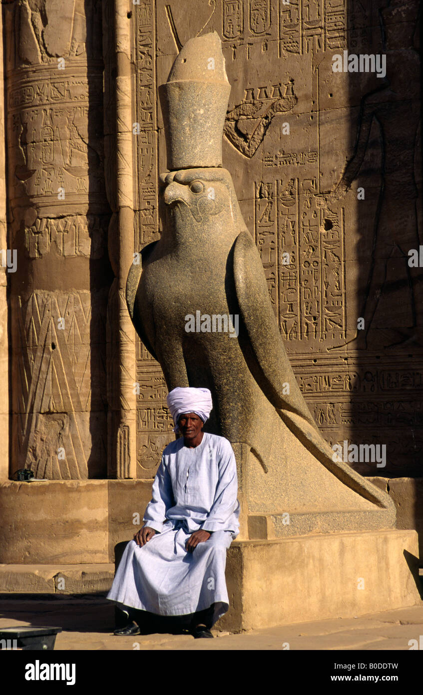 Egyptian guard sitting down by the Horus statue in the Horus Temple in ...