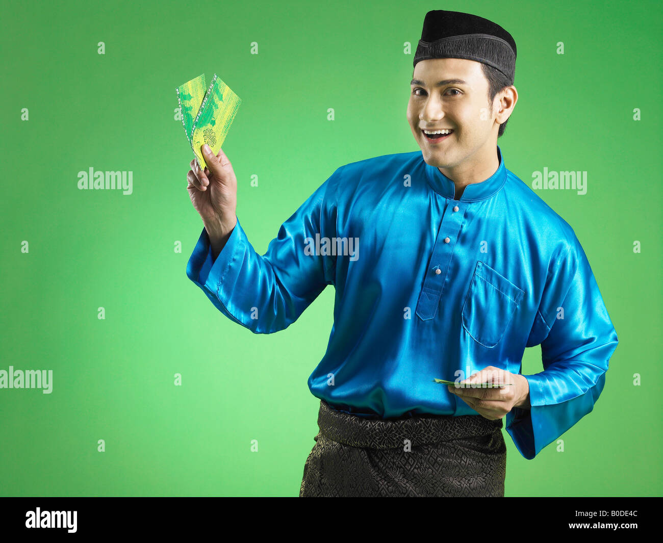 Asian man holding duit raya Stock Photo - Alamy