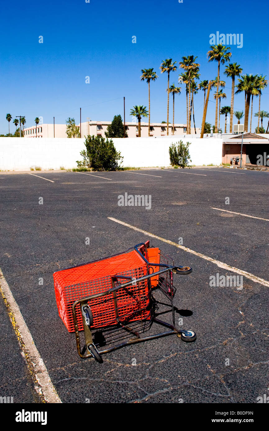 A shopping cart is tipped over in a parking lot Stock Photo - Alamy