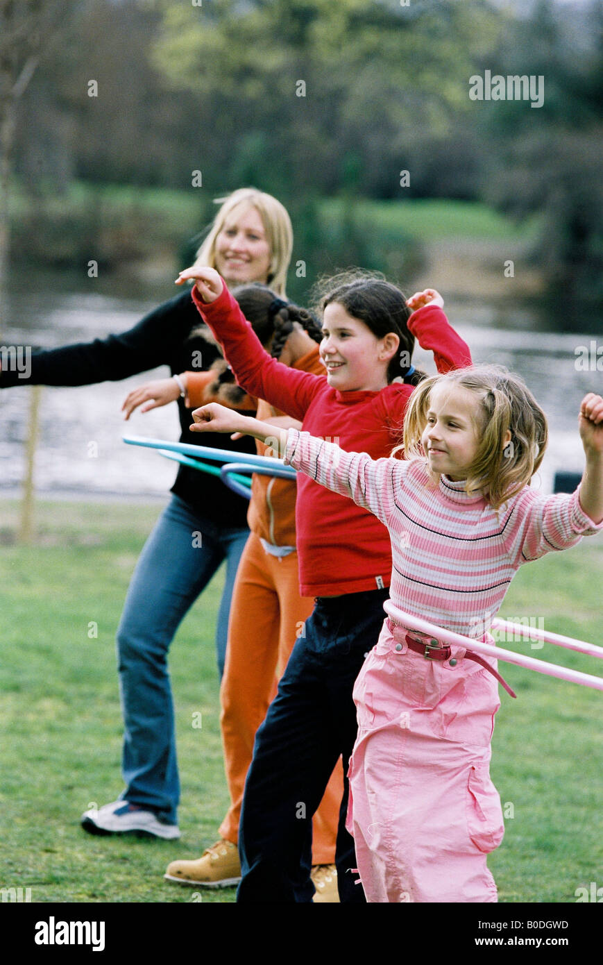 Teacher and school children playing Stock Photo - Alamy