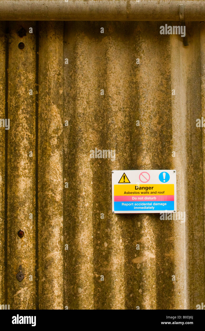 Asbestos warning sign on asbestos wall Stock Photo - Alamy