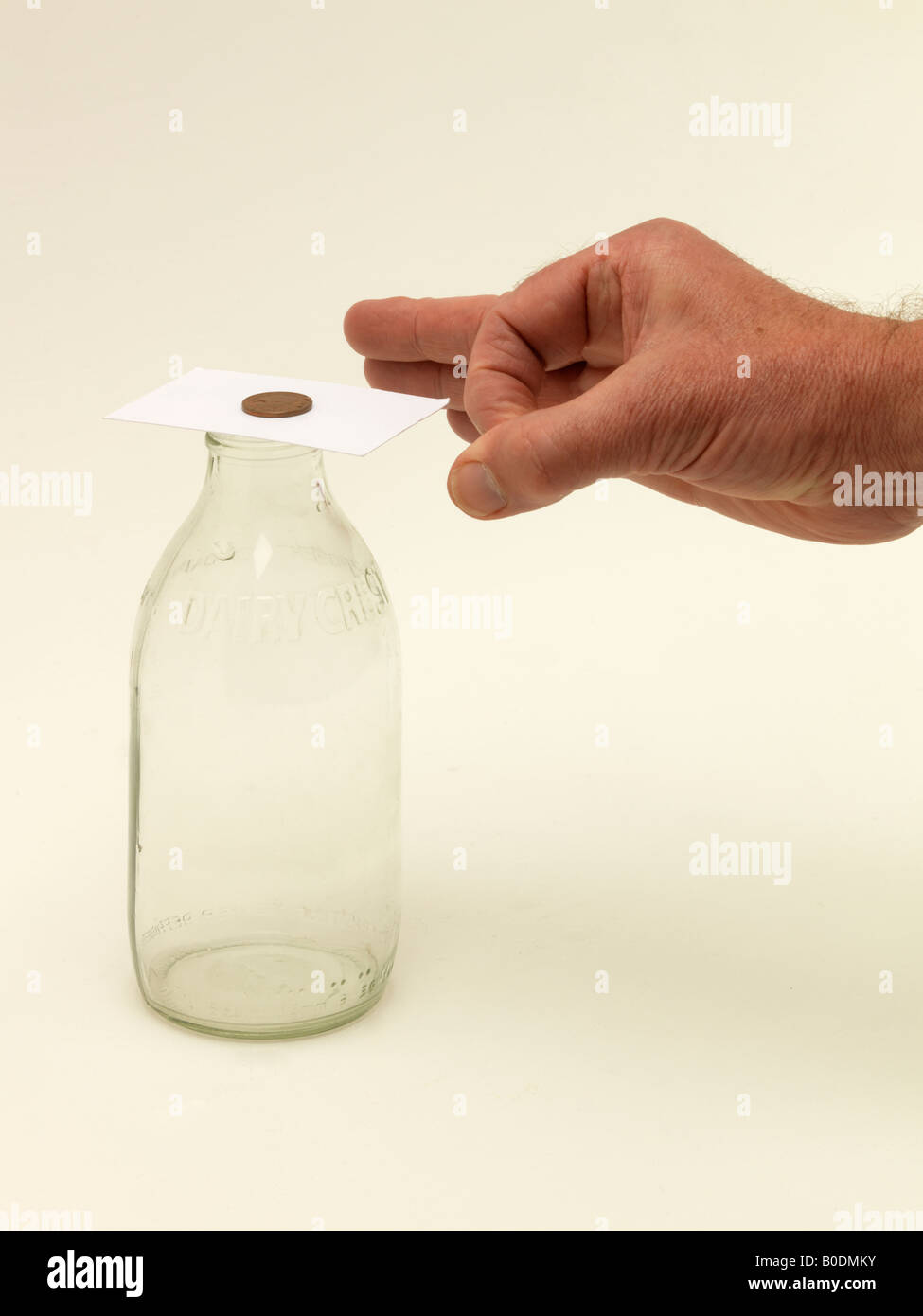 Card Coin and Bottle Trick Stock Photo - Alamy