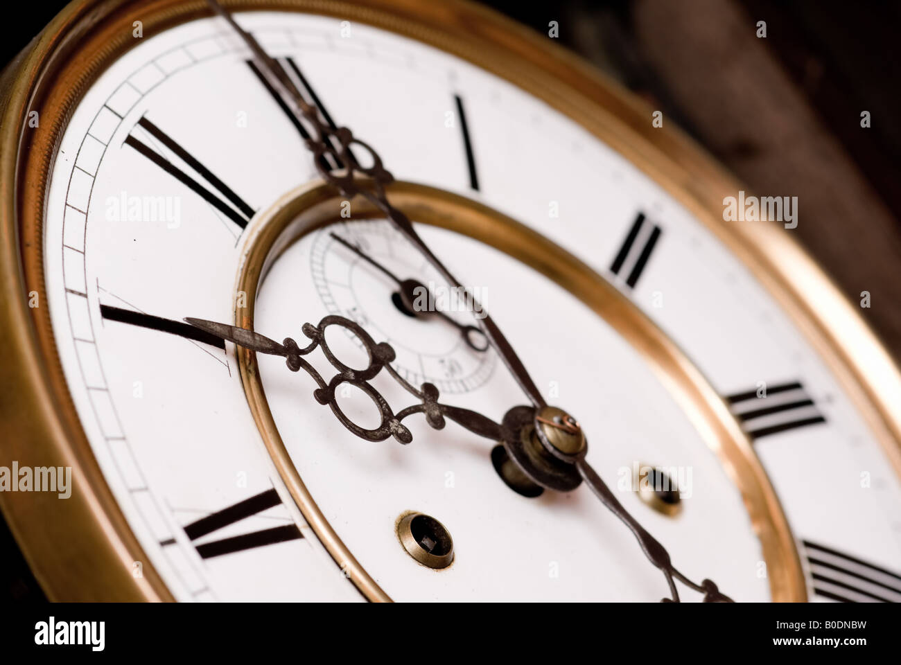 Old clock face with roman numerals - focus on hour hand Stock Photo - Alamy