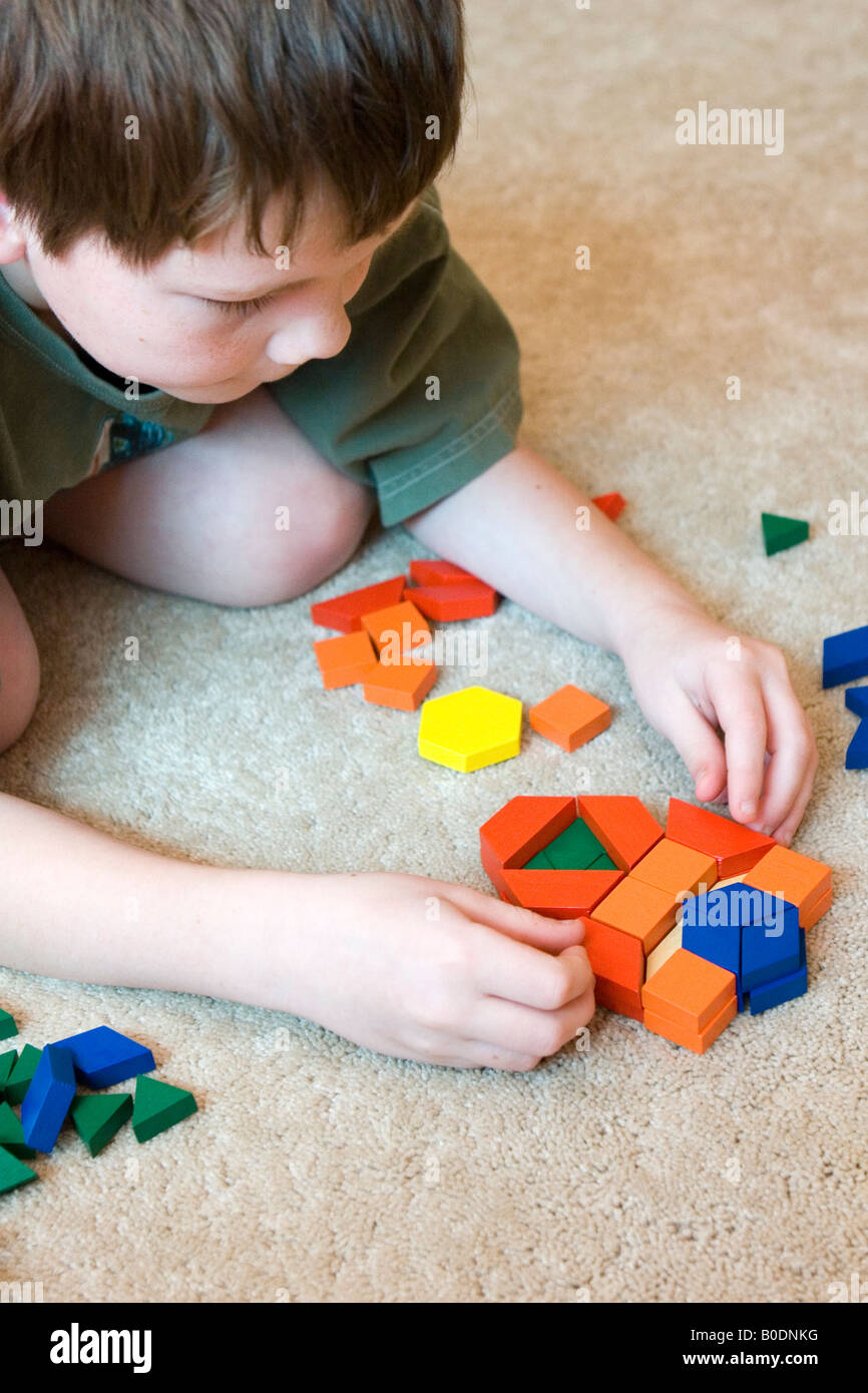 Young Boy Playing with Various Geometric Shapes Stock Photo - Alamy