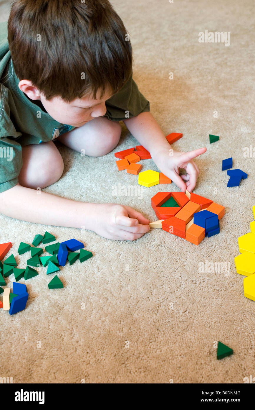Young Boy Playing with Various Geometric Shapes Stock Photo - Alamy