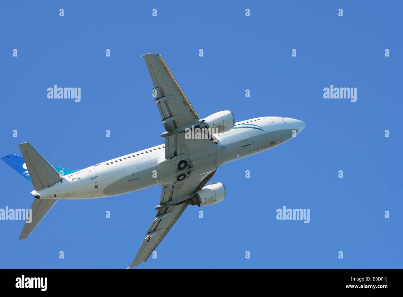 Underside view of turning jet plane Stock Photo - Alamy
