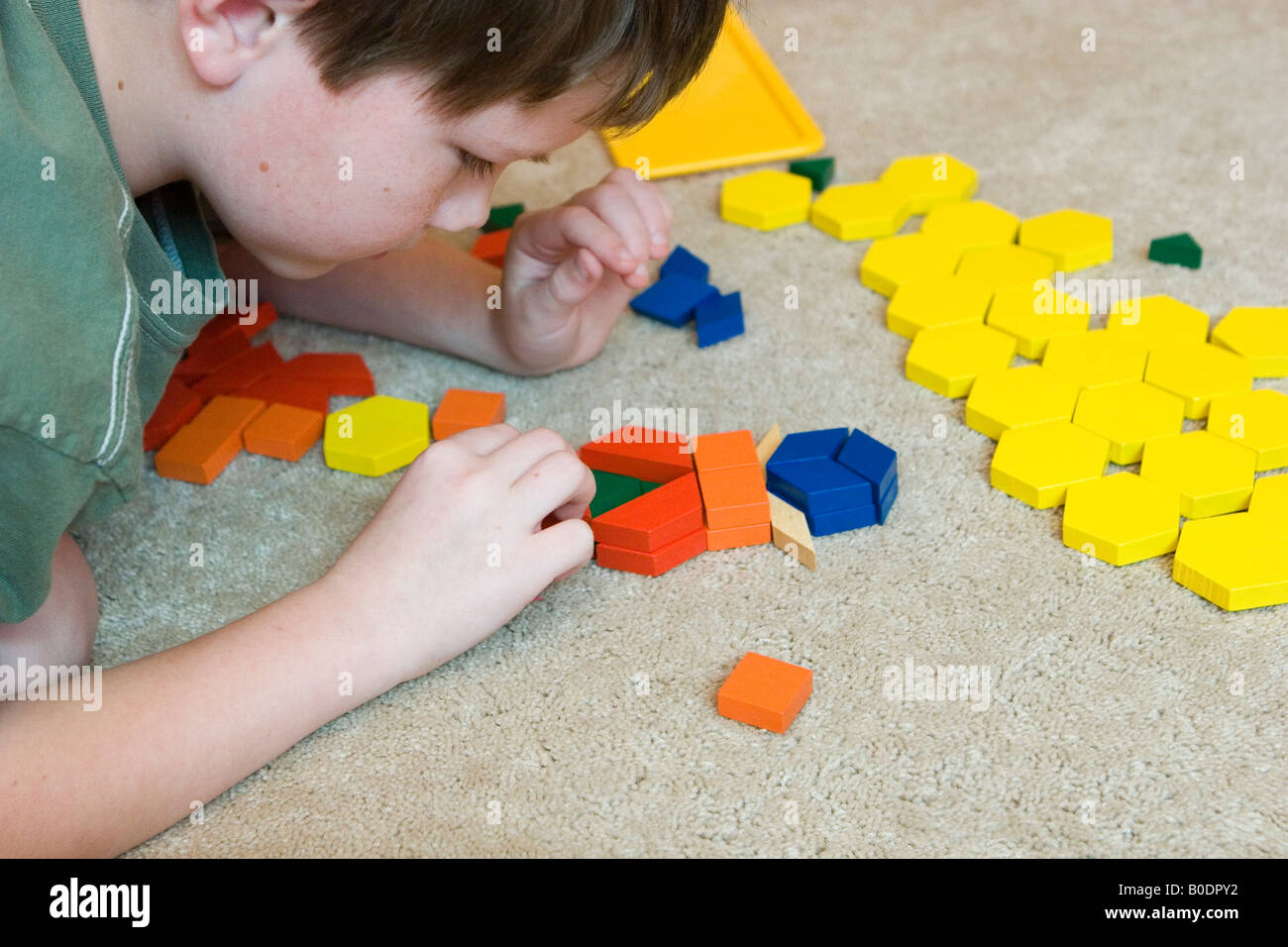 Young Boy Playing with Various Geometric Shapes Stock Photo - Alamy
