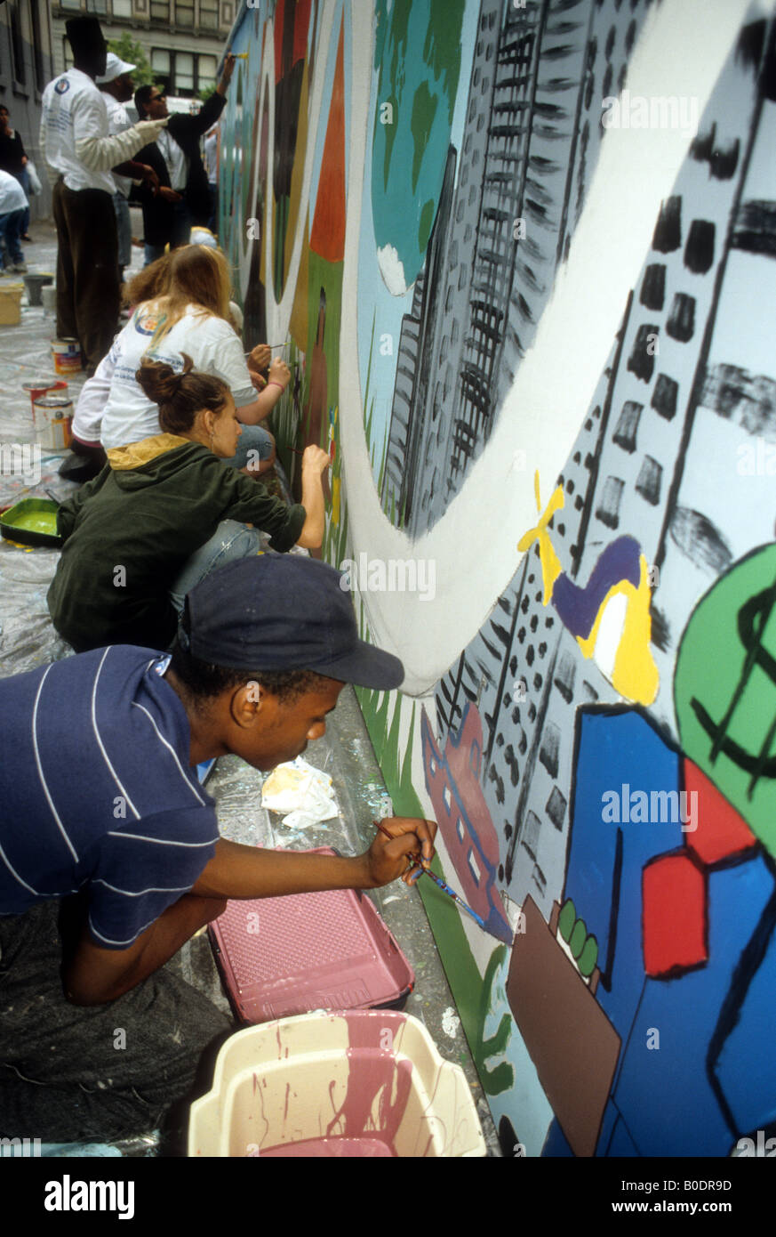 Volunteers paint a mural in Union Square Park in New York designed by ...