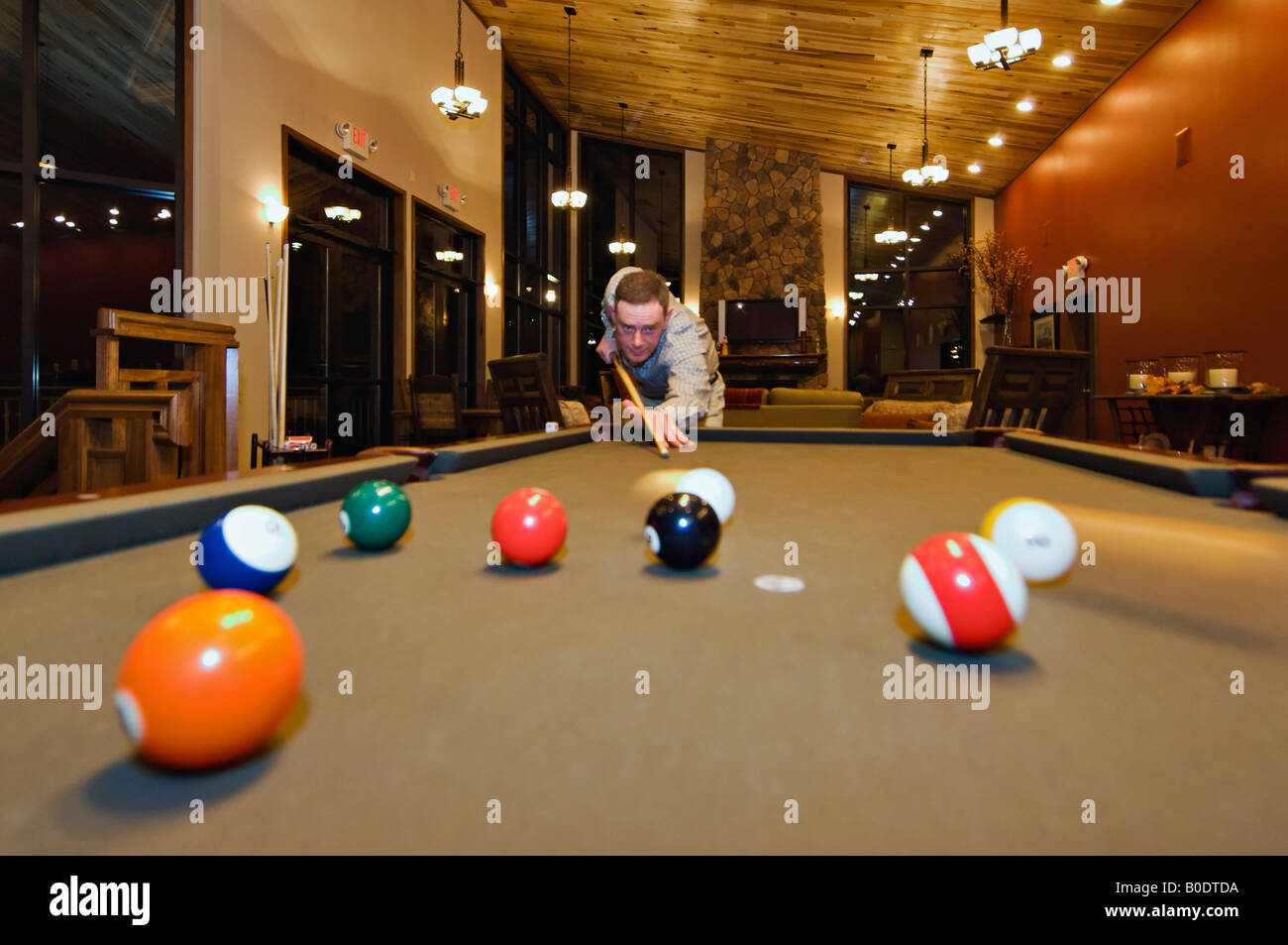 Man Playing Pool in Hunting Lodge Stock Photo - Alamy