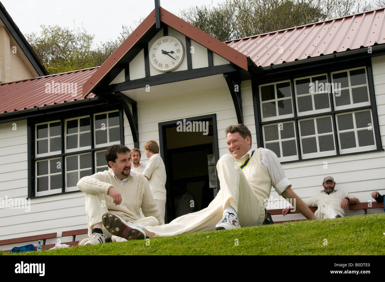 Cricketers sitting outside the pavilion relaxing in the tea interval at ...