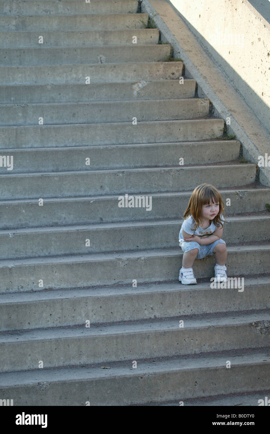 Girl sitting on staircase Stock Photo - Alamy