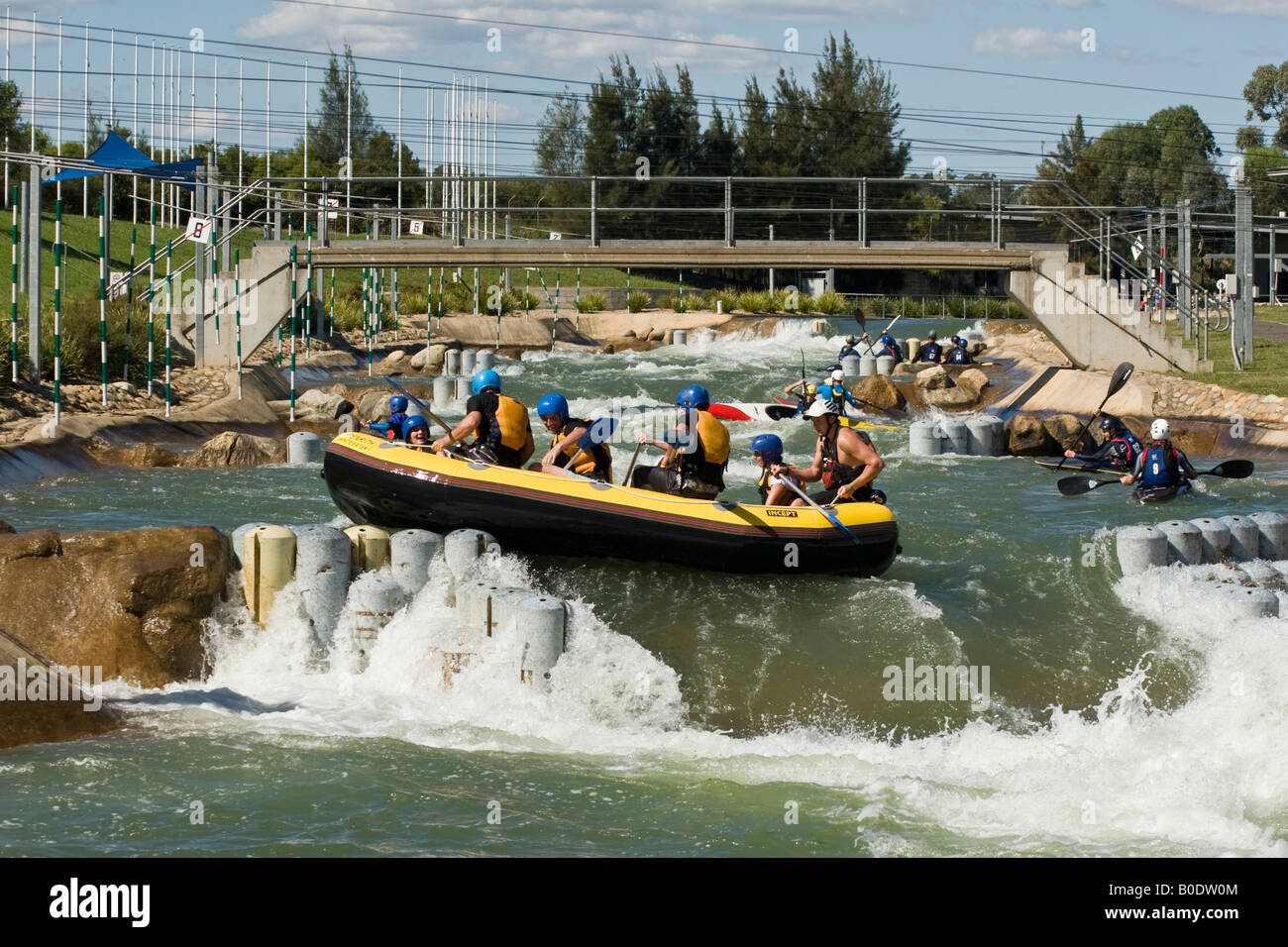 A raft full of people slide over the rapids on the Penrith Whitewater ...