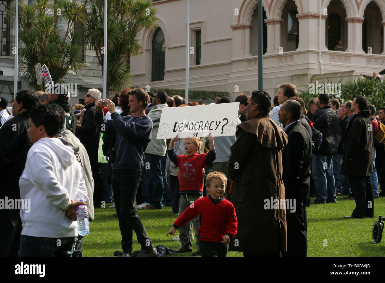 Little kid at political rally, carrying placard "Democracy Stock Photo ...