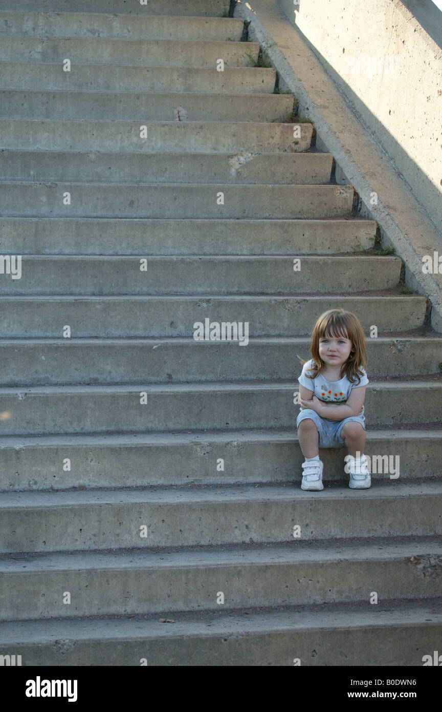Portrait of a girl sitting on staircase Stock Photo - Alamy