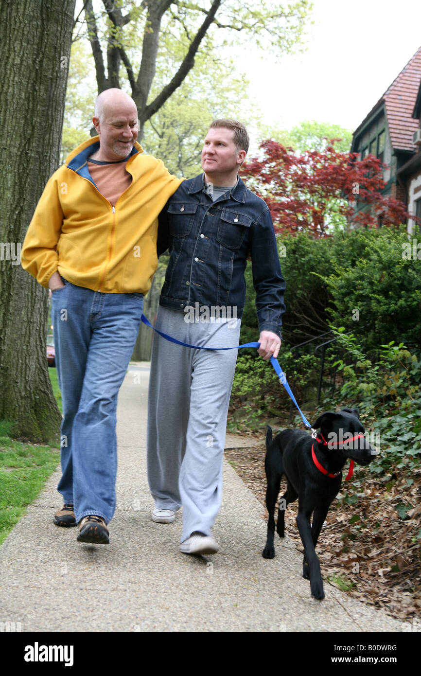 Gay male couple walking dog hi-res stock photography and images - Alamy