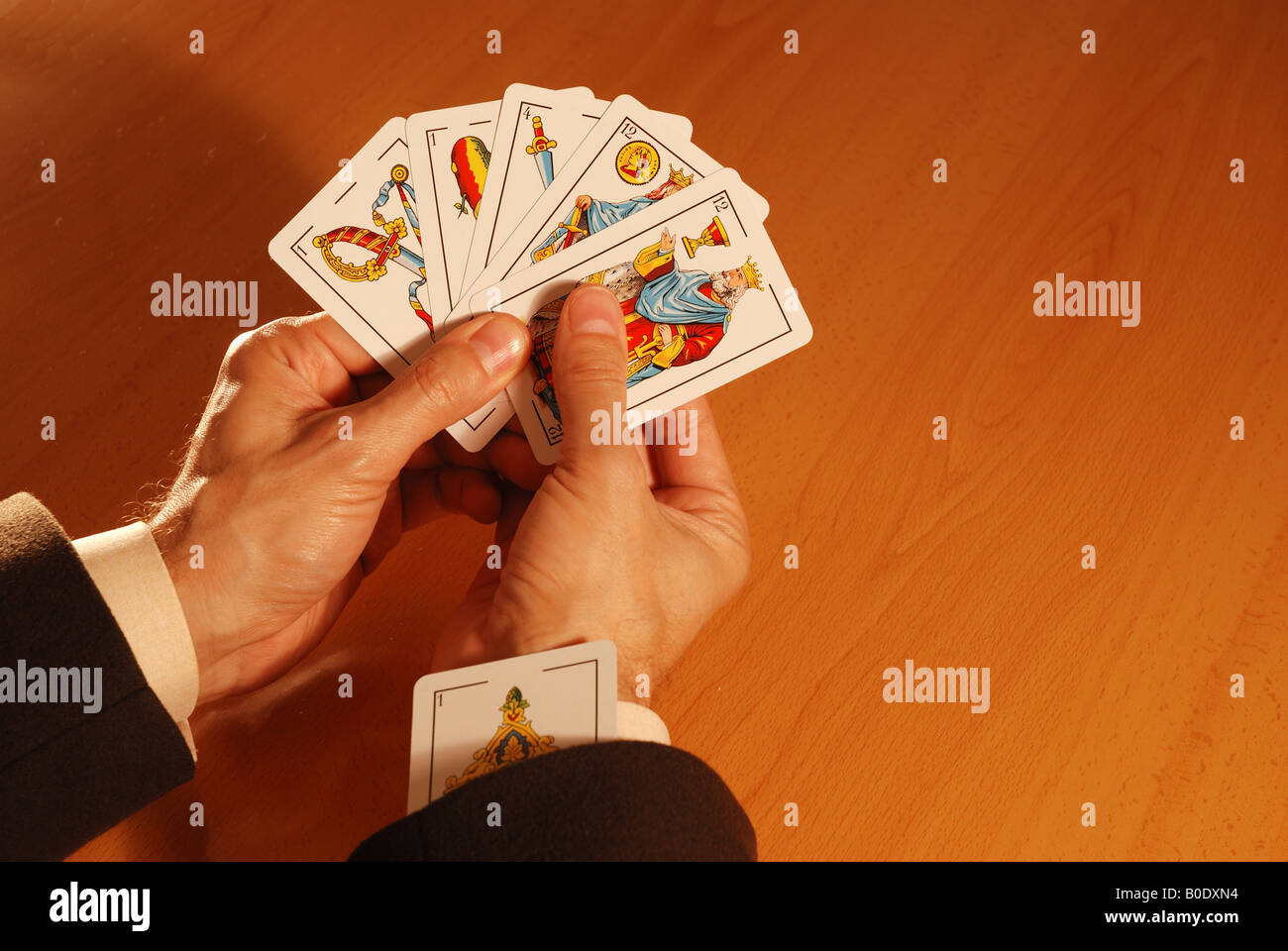 Hands playing cards. Cheating Stock Photo - Alamy