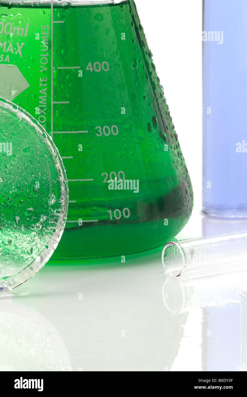 Beakers With Colorful Liquids On Wet Counter White Background Stock ...