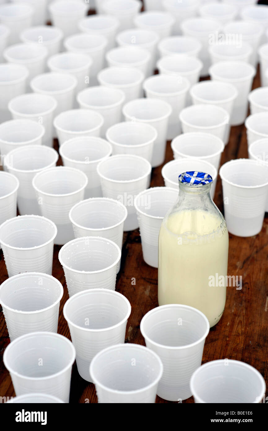 rows of empty white plastic cups with milk bottle Stock Photo - Alamy