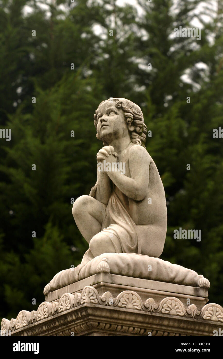 Bogota Central Cemetery small boy statue praying Stock Photo - Alamy