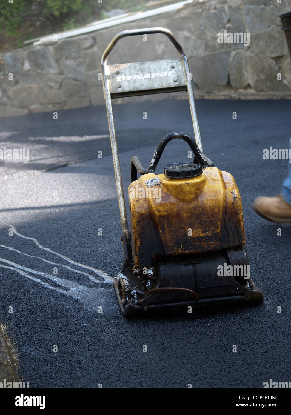 Asphalt stamping equipment on newly construction driveway Stock Photo ...