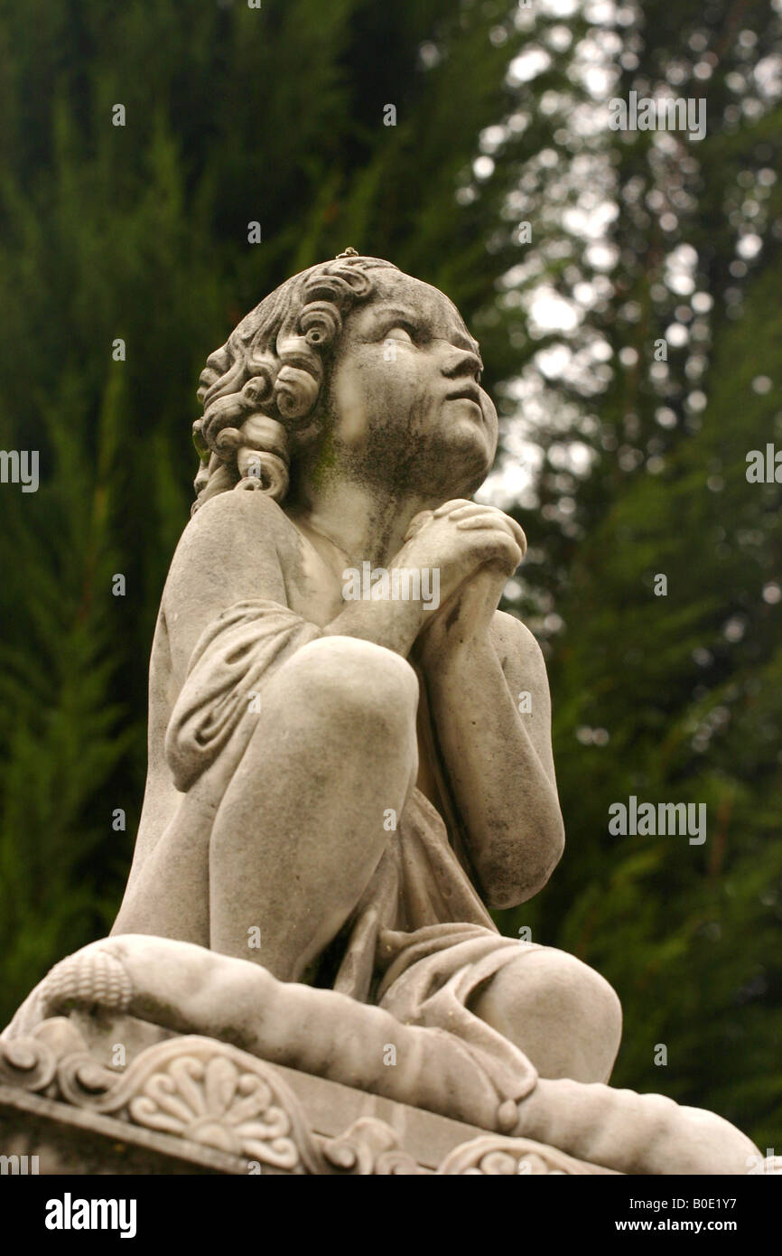 Bogota Central Cemetery small boy statue praying Stock Photo - Alamy