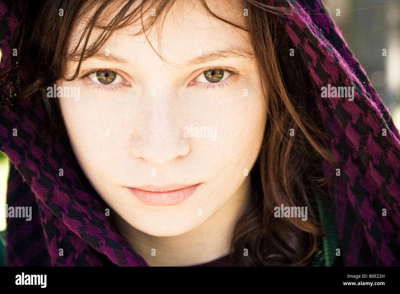 Beautiful woman covered by violet veil Stock Photo - Alamy