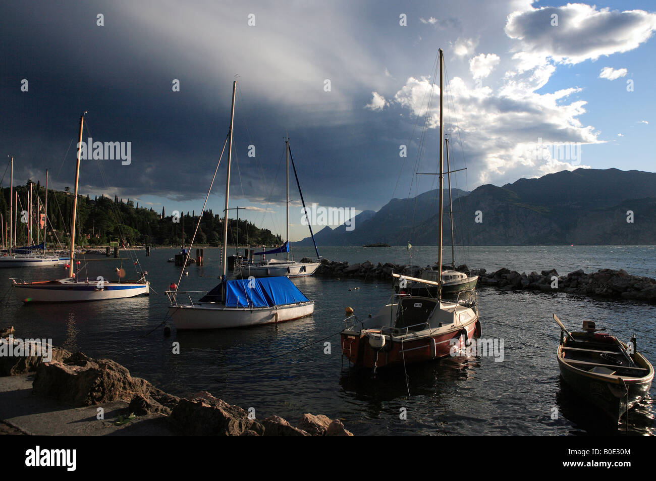 Riverside boats in Italy Stock Photo - Alamy