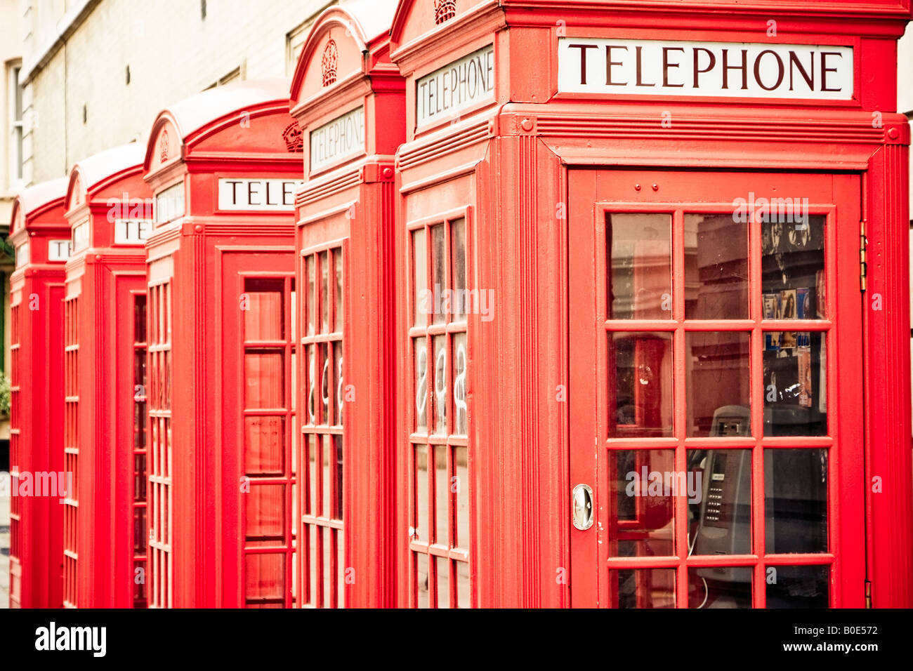 Five red phone boxes grunge toned Stock Photo - Alamy