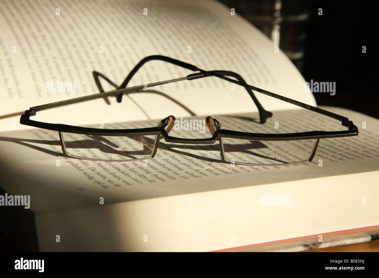 Reading glasses on an open book Stock Photo - Alamy